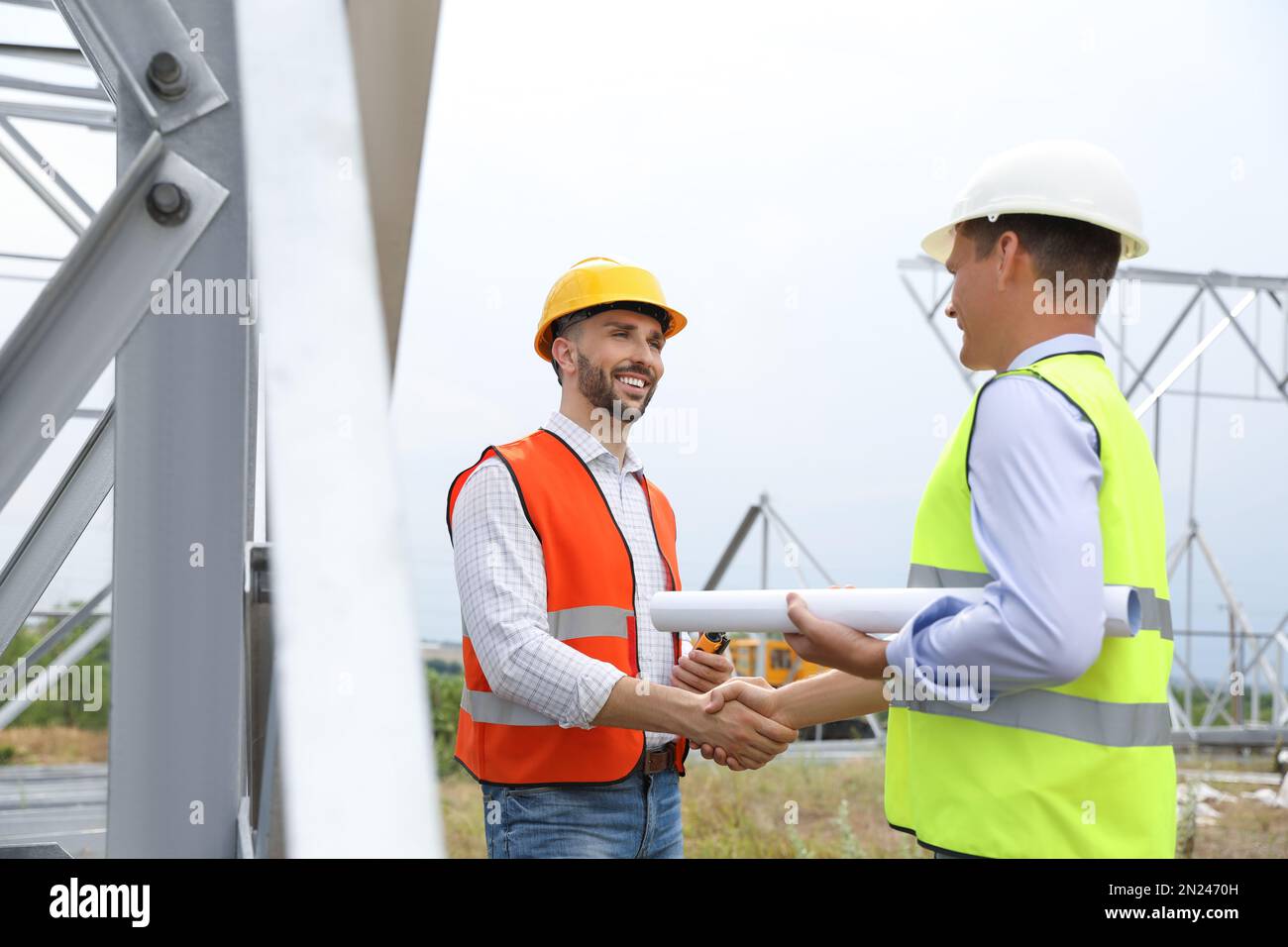 Professional engineers working on installation of electrical substation ...