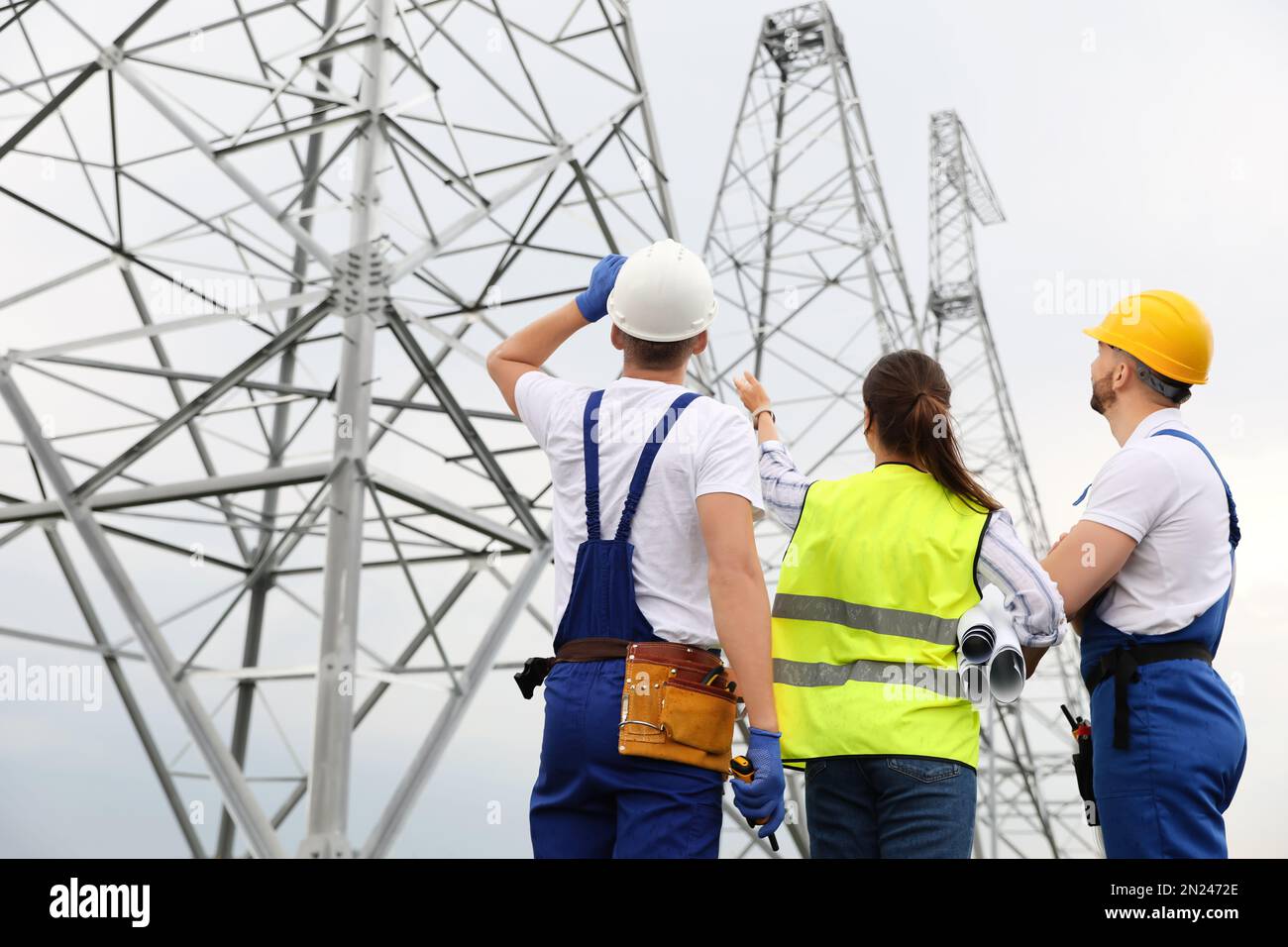Professional engineers working on installation of electrical substation ...
