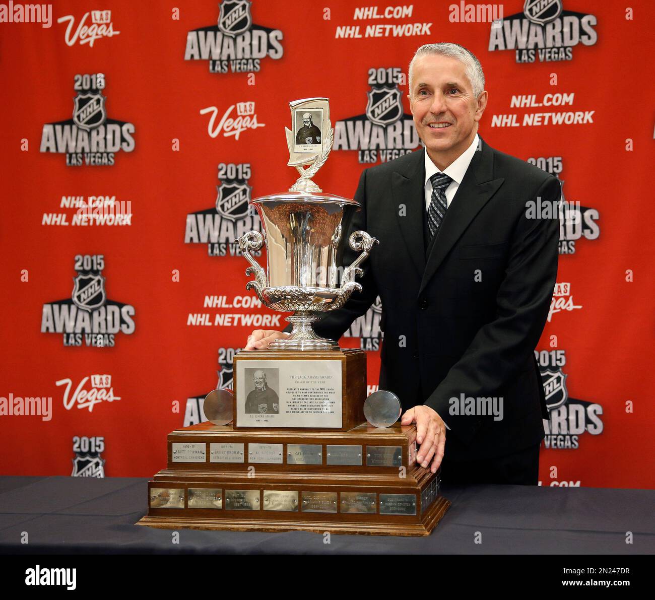 Calgary Flames coach Bob Hartley poses with the Jack Adams Award trophy ...