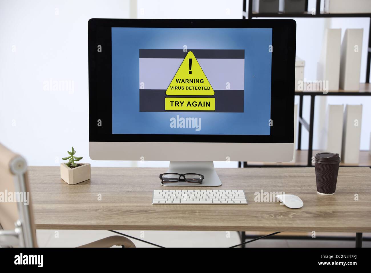 Computer with warning about virus attack on screen in office Stock ...