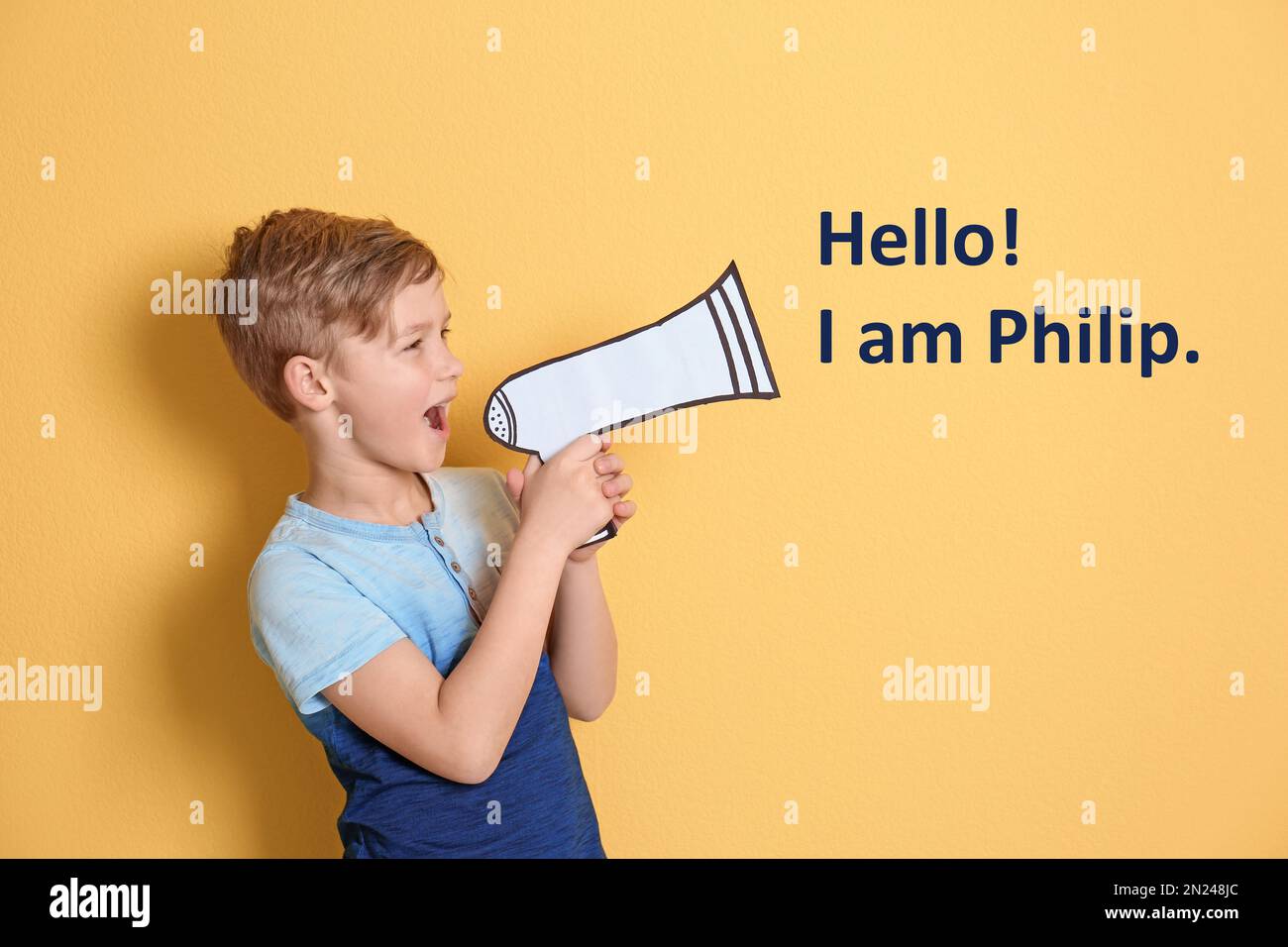 Cute little boy saying Hello! I Am Philip using paper megaphone on ...