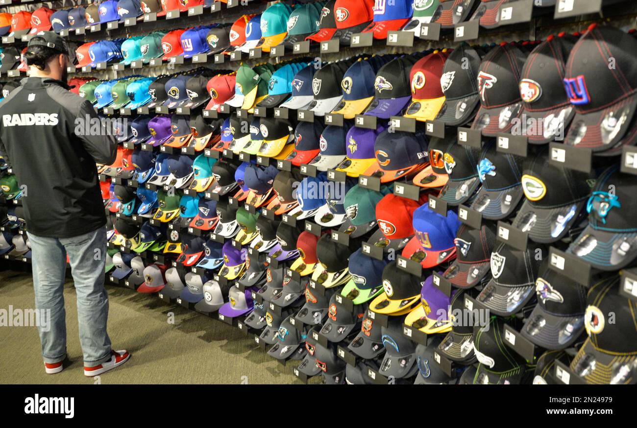 Oakland Raiders linebacker Ben Heeney views the ball cap rack in the ...