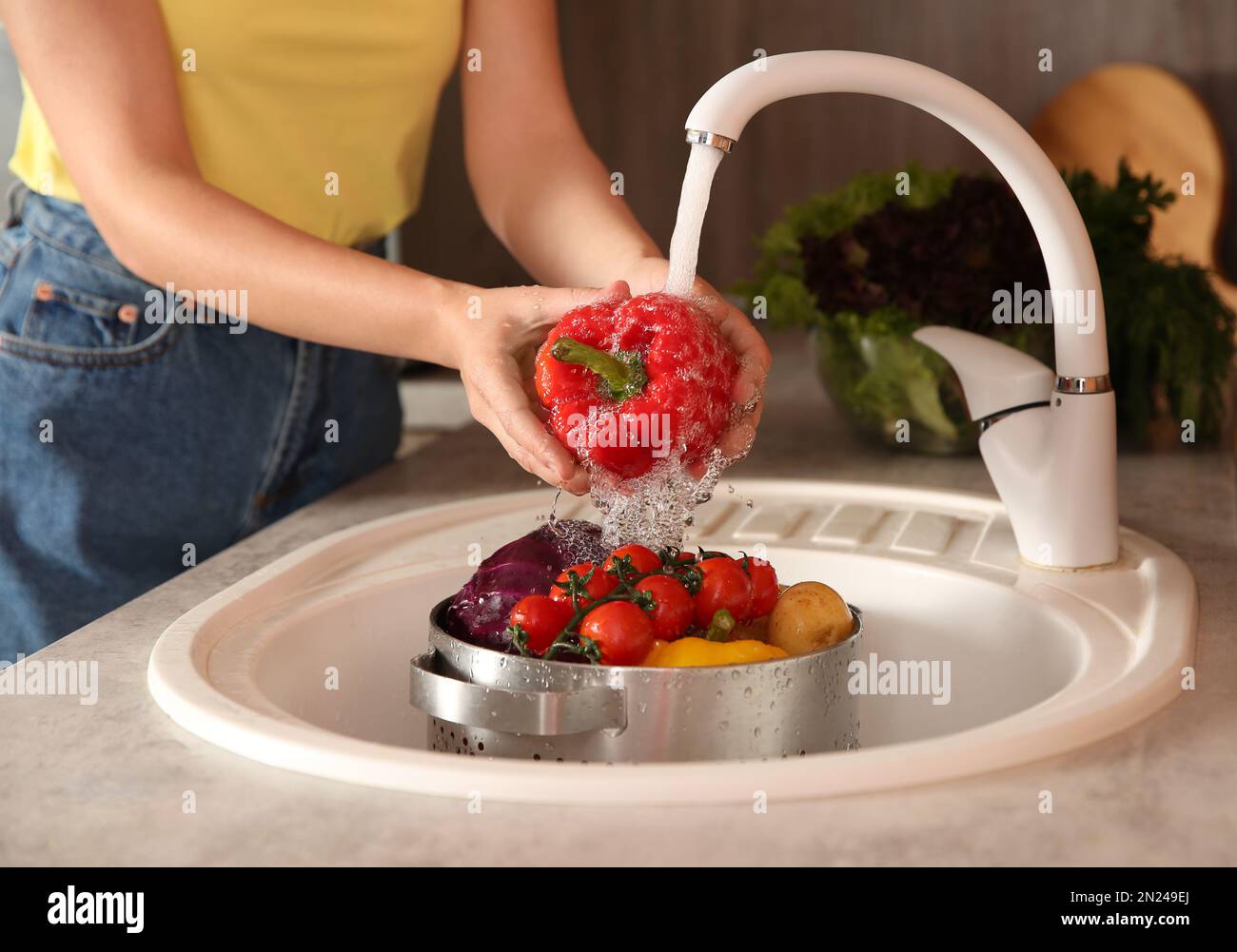 Woman washing fresh red bell pepper in kitchen sink, closeup Stock ...
