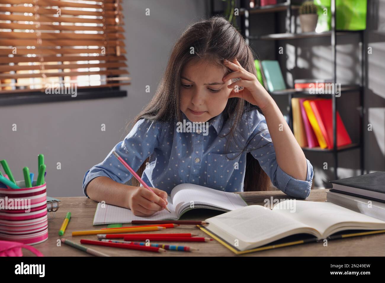 Cute student girl sitting table hi-res stock photography and images - Alamy