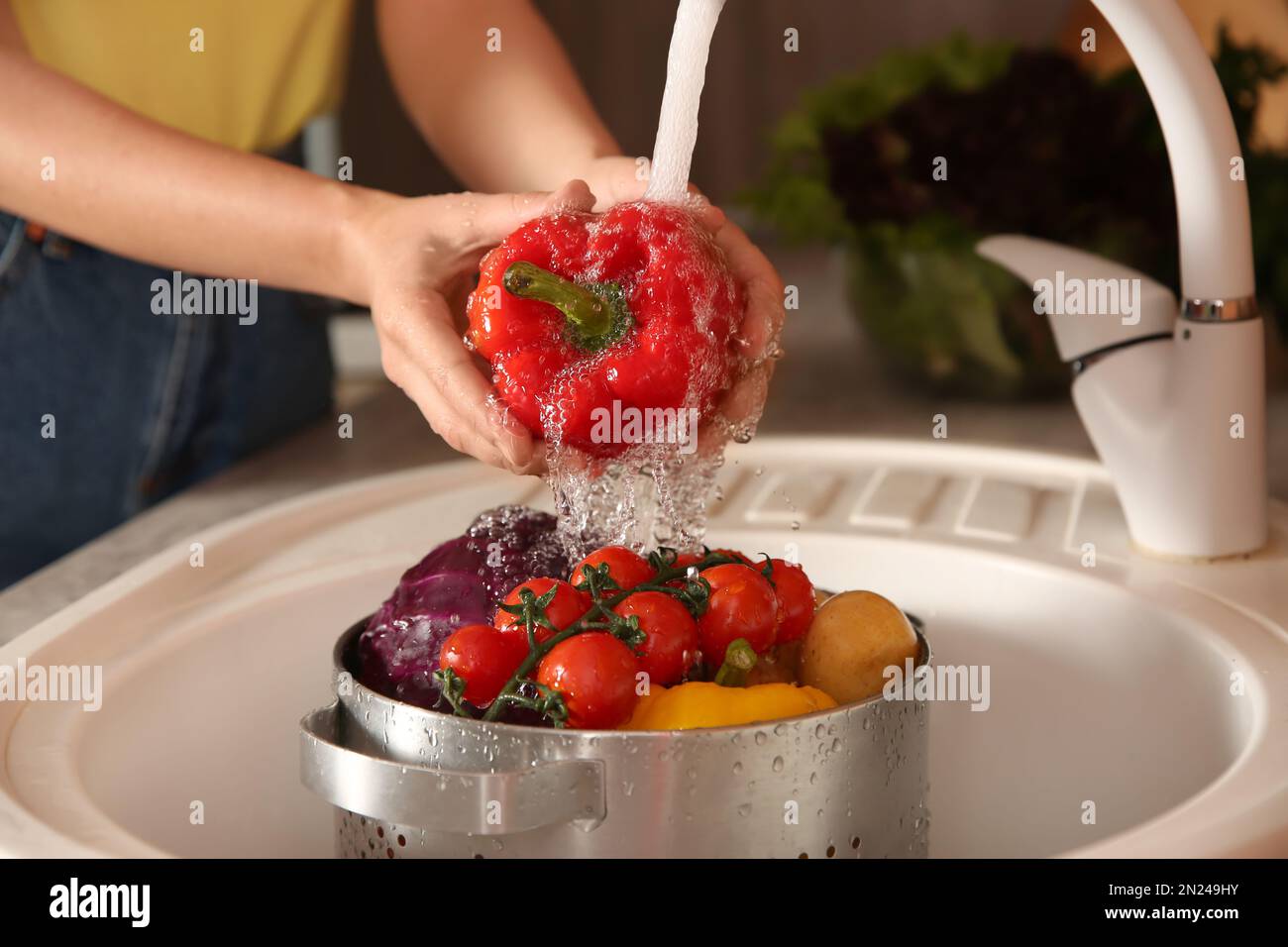 Woman washing fresh red bell pepper in kitchen sink, closeup Stock ...