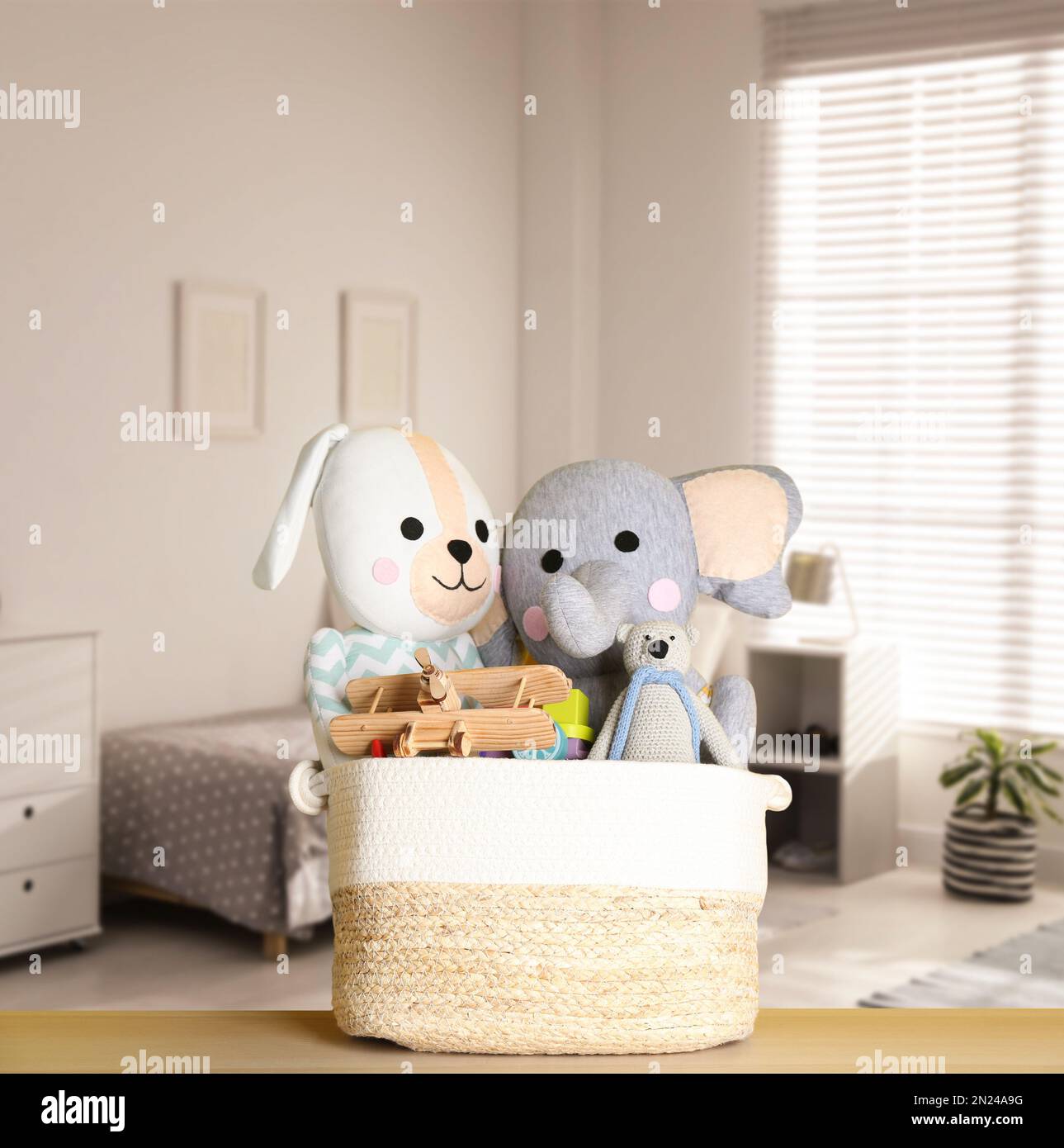 Set of different cute toys on wooden table in children's room Stock ...