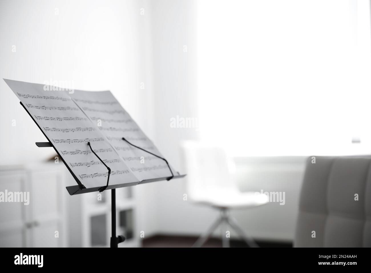Note stand with music sheets indoors, space for text Stock Photo - Alamy