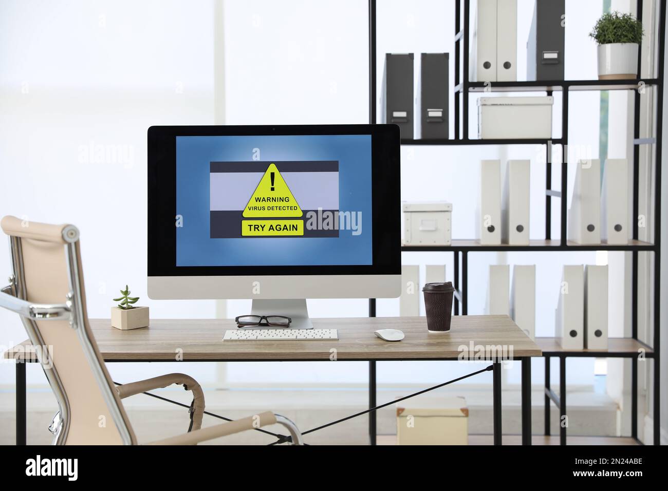 Computer with warning about virus attack on screen in office Stock ...