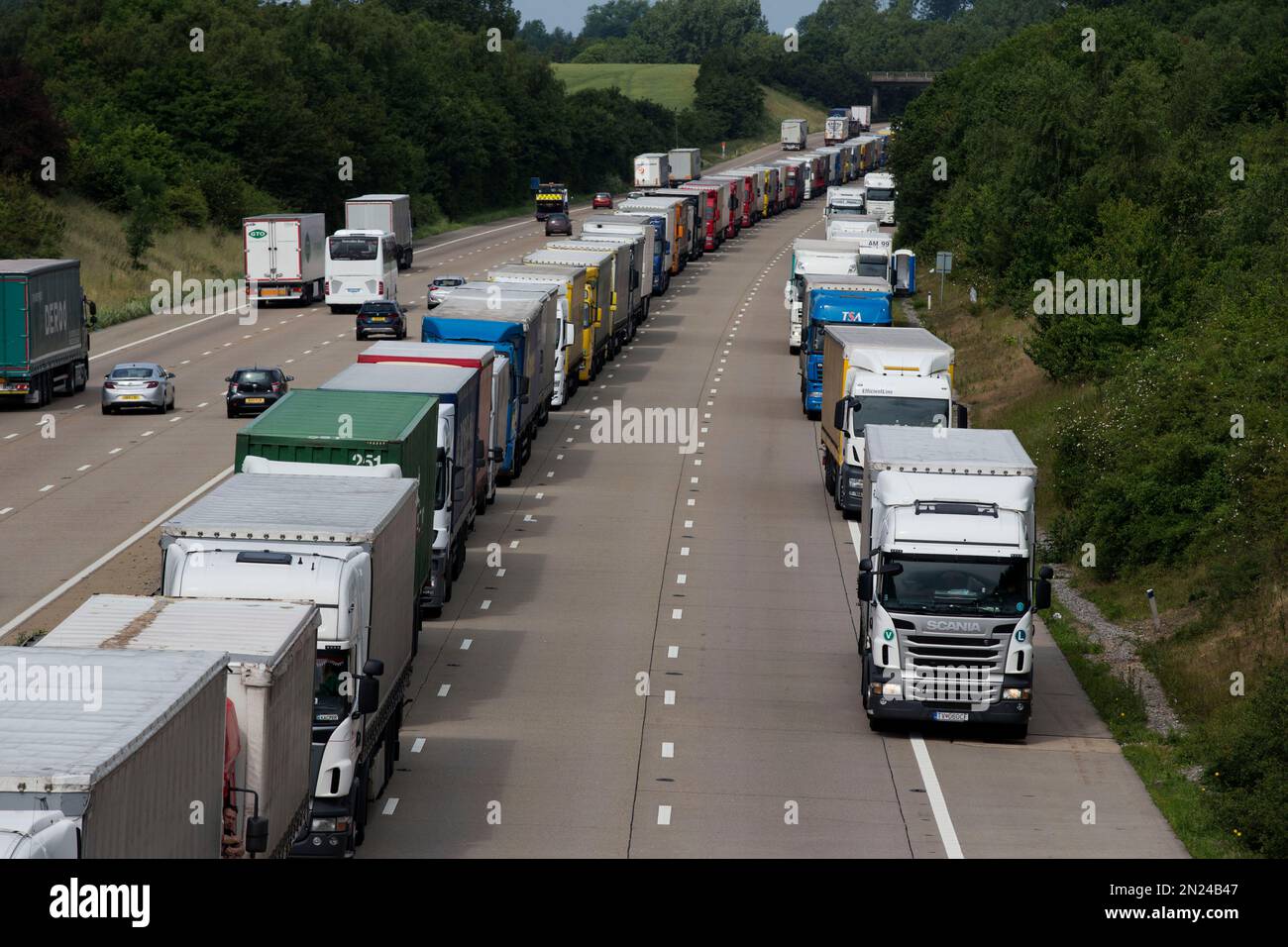 Lorries stand queued up between junctions 8 and 9 of the M20 motorway ...