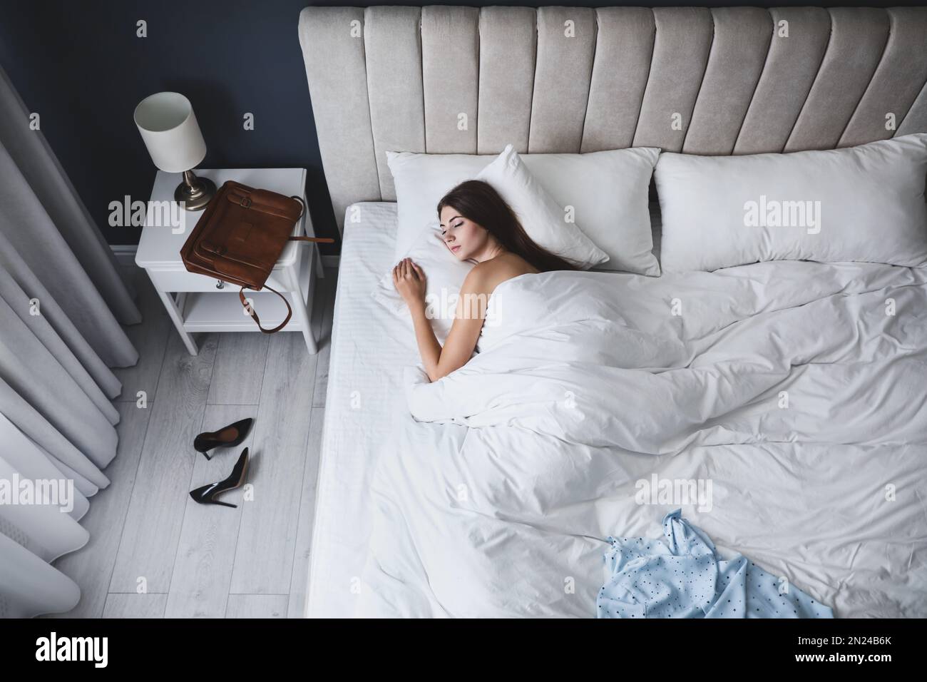Tired woman sleeping in bed at home after work, above view Stock Photo ...