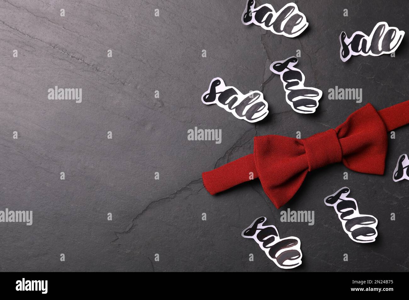 Bow tie, words Sale and space for text on dark background, flat lay ...