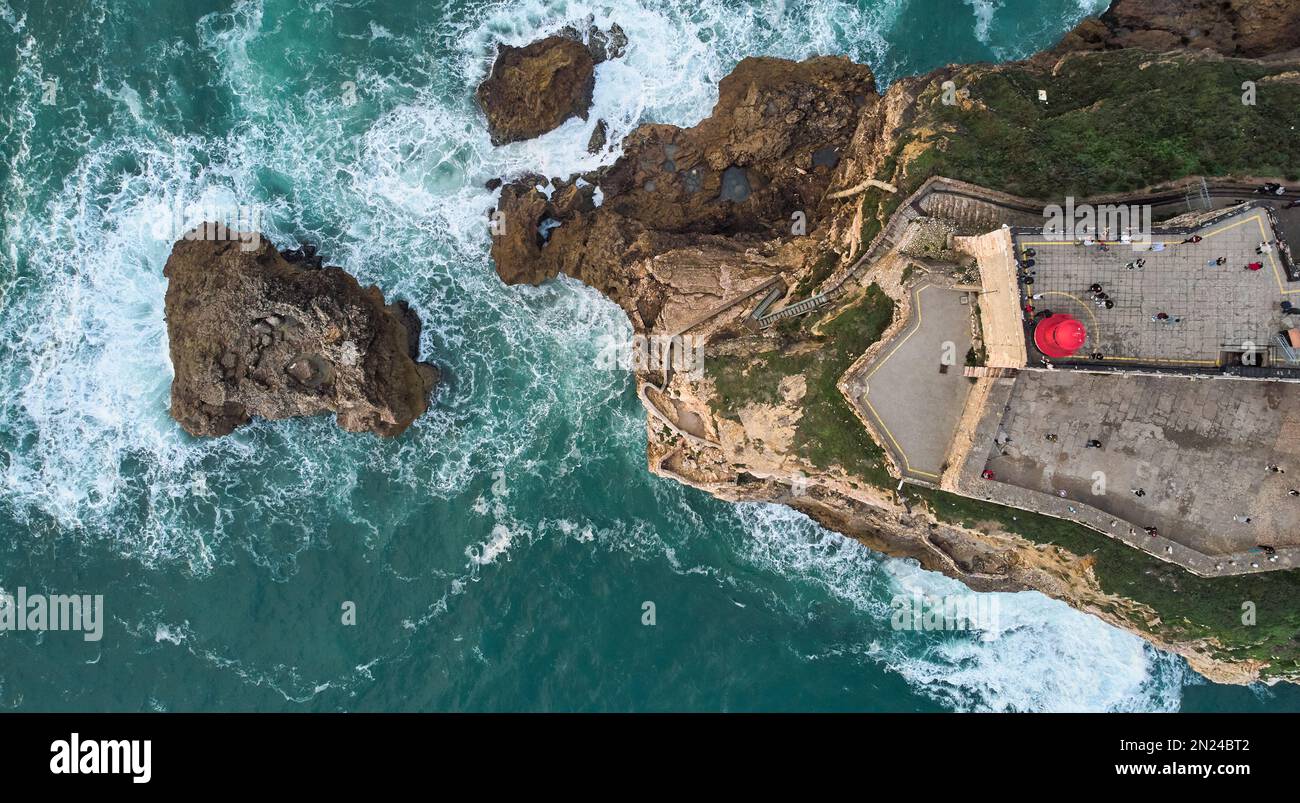Aerial view of an old lighthouse on a cliff with a fortress on the ...