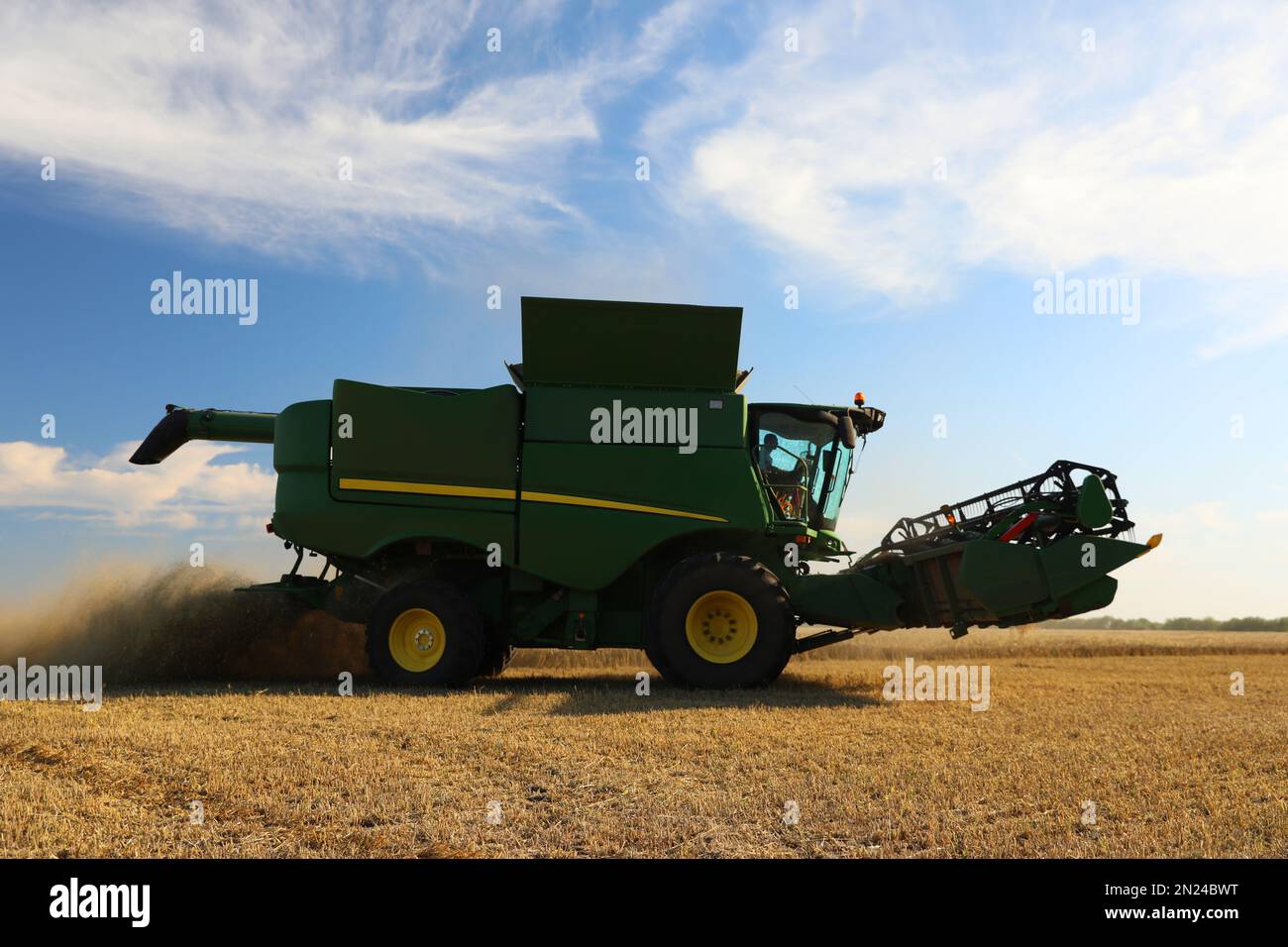 Modern combine harvester working in agricultural field Stock Photo - Alamy