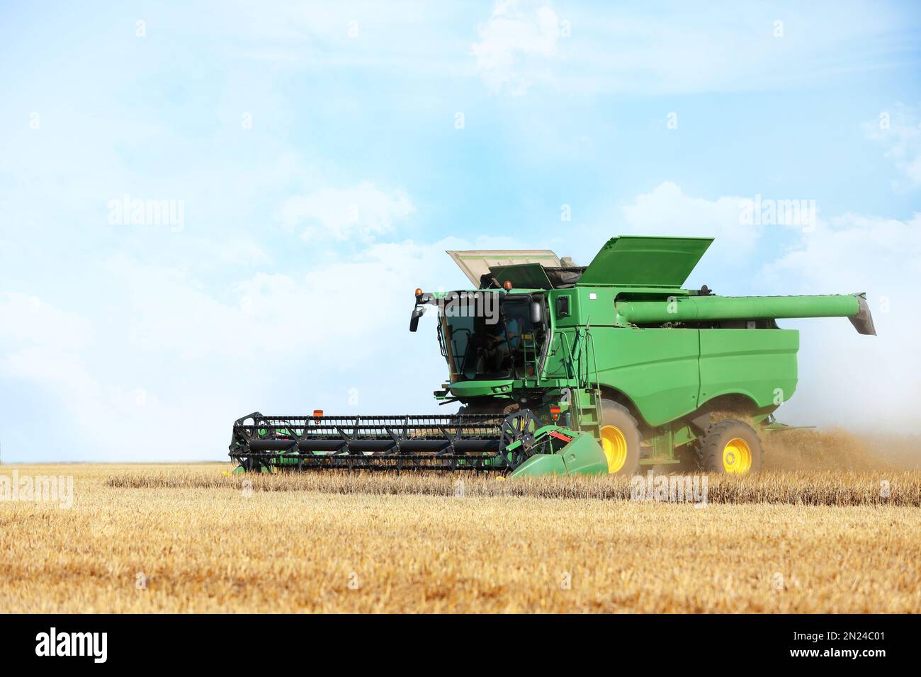 Modern combine harvester working in agricultural field Stock Photo - Alamy