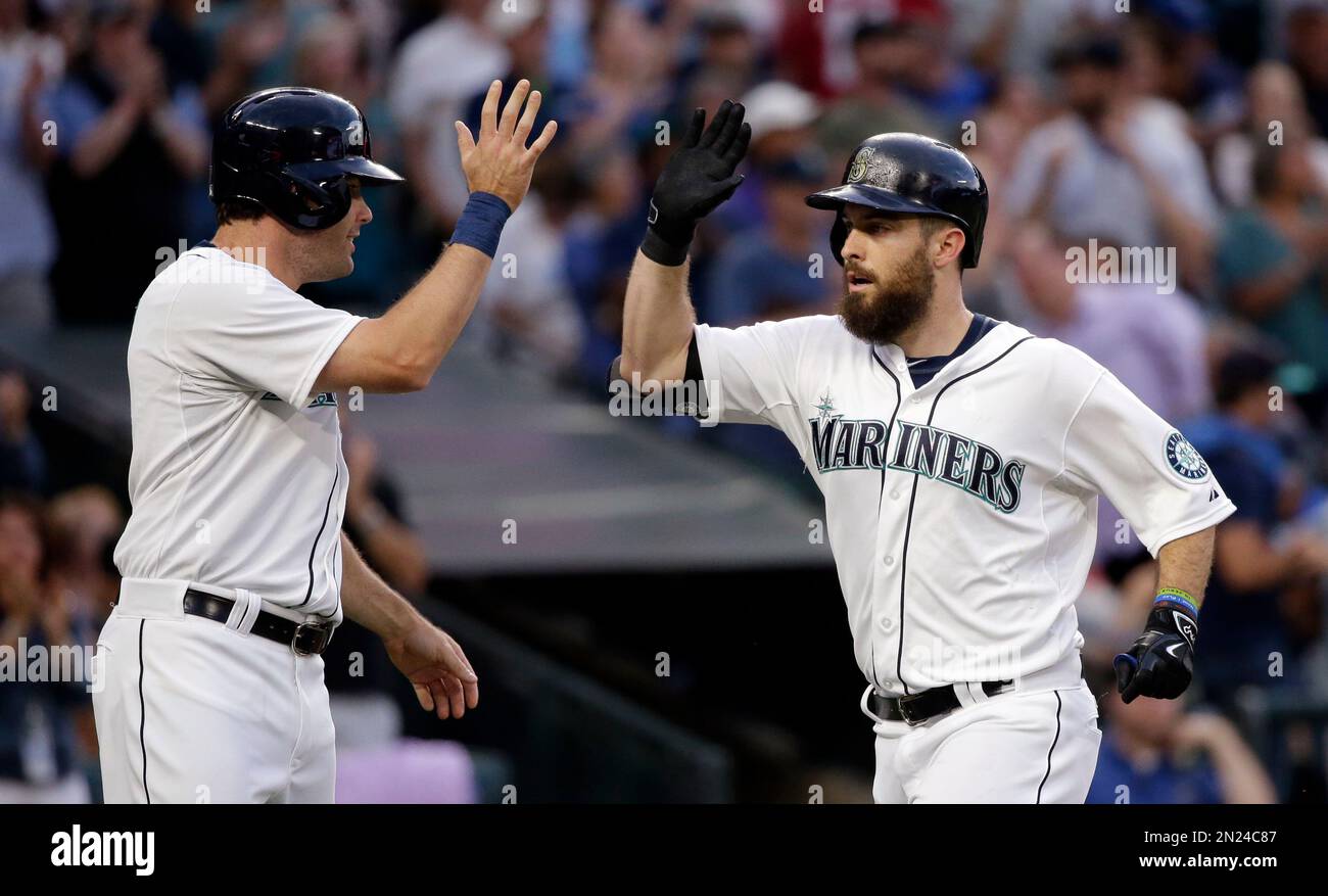 Seattle Mariners' Dustin Ackley, right, is met at home by Seth Smith on ...