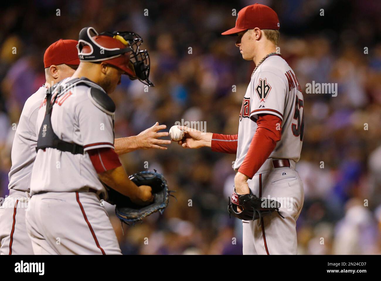 Arizona Diamondbacks starting pitcher Chase Anderson, right, hands the ...
