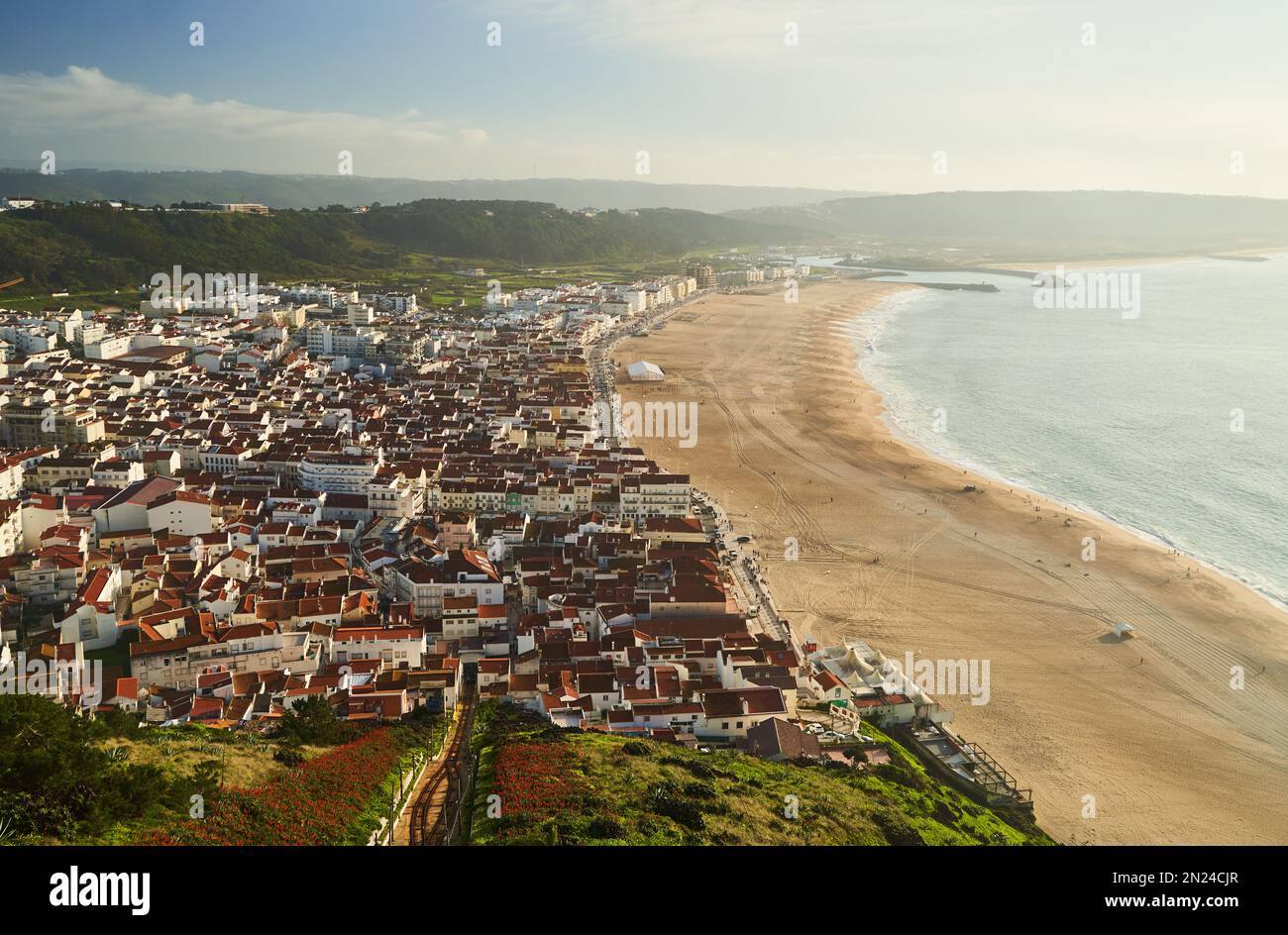 View Nazare beach riviera with cityscape of Nazare town at sunny ...