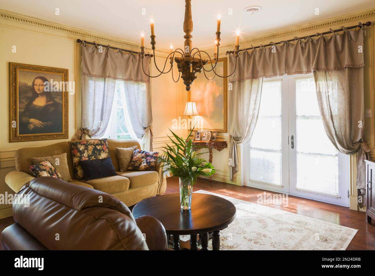 Brown leather reclining armchair and round wooden coffee table, beige ...