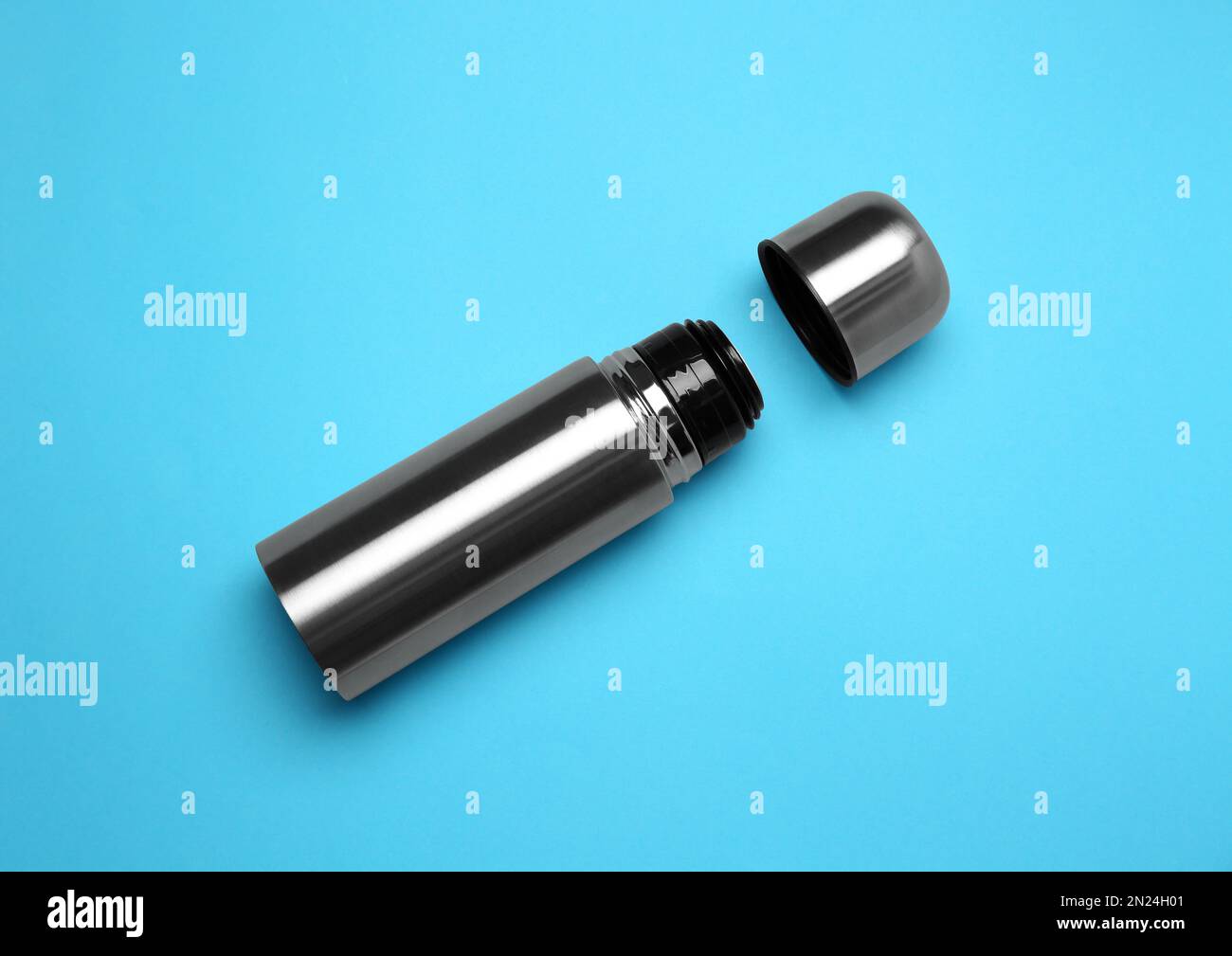 Stainless steel thermos on light blue background, top view Stock Photo ...
