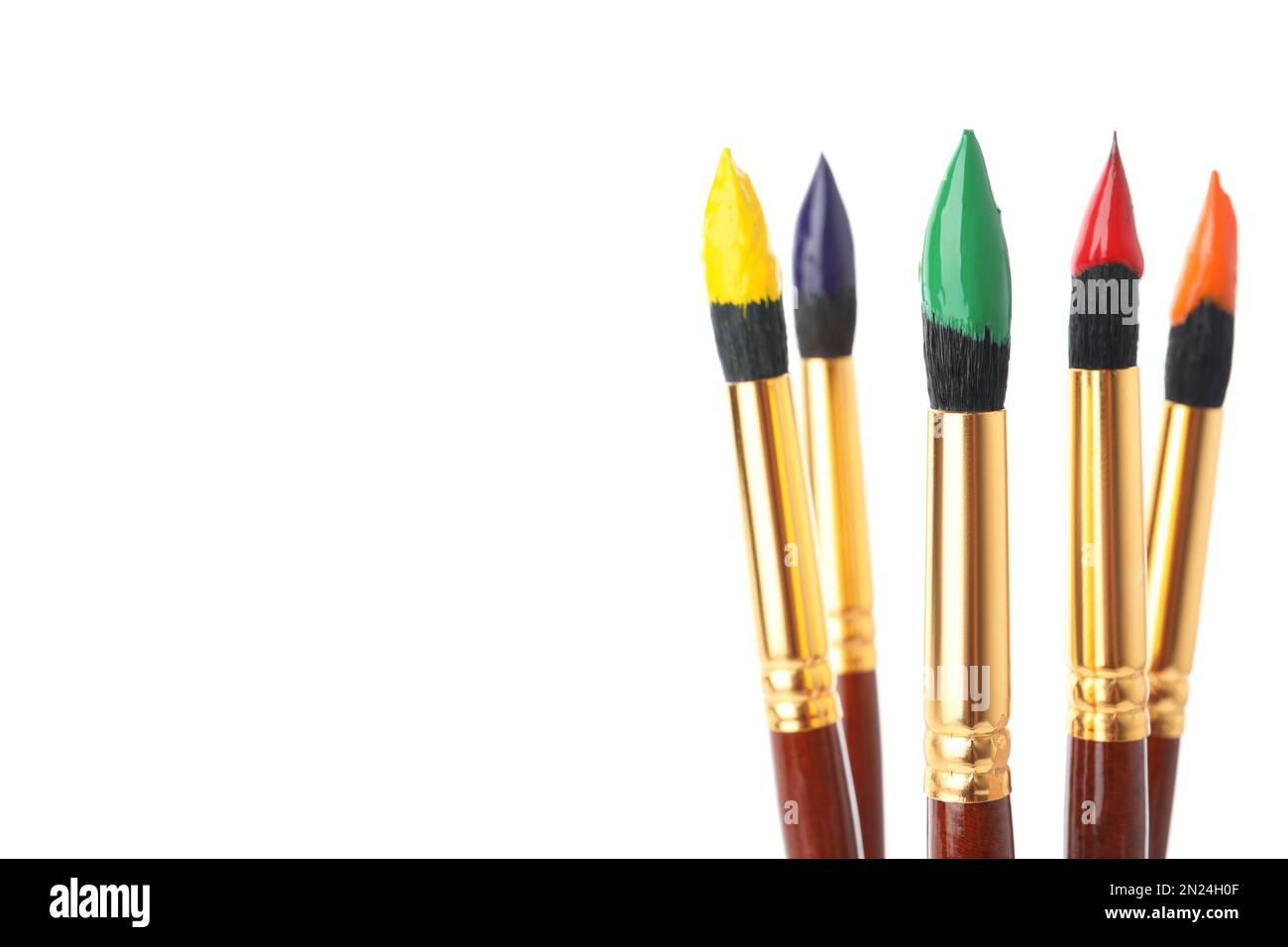 Brushes with colorful paints on white background Stock Photo - Alamy