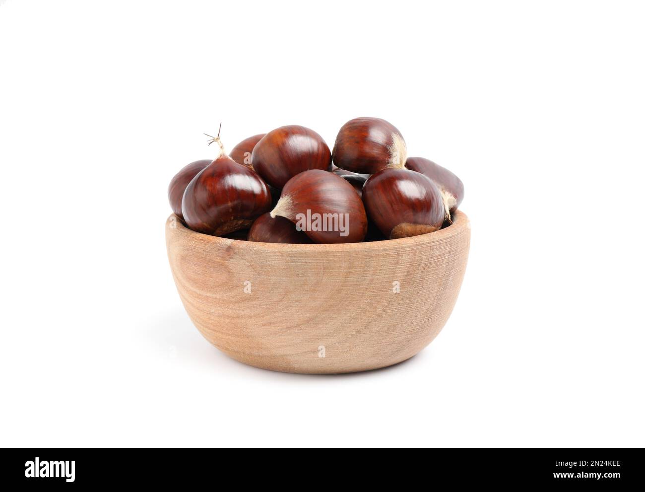 Fresh sweet edible chestnuts in wooden bowl on white background Stock ...