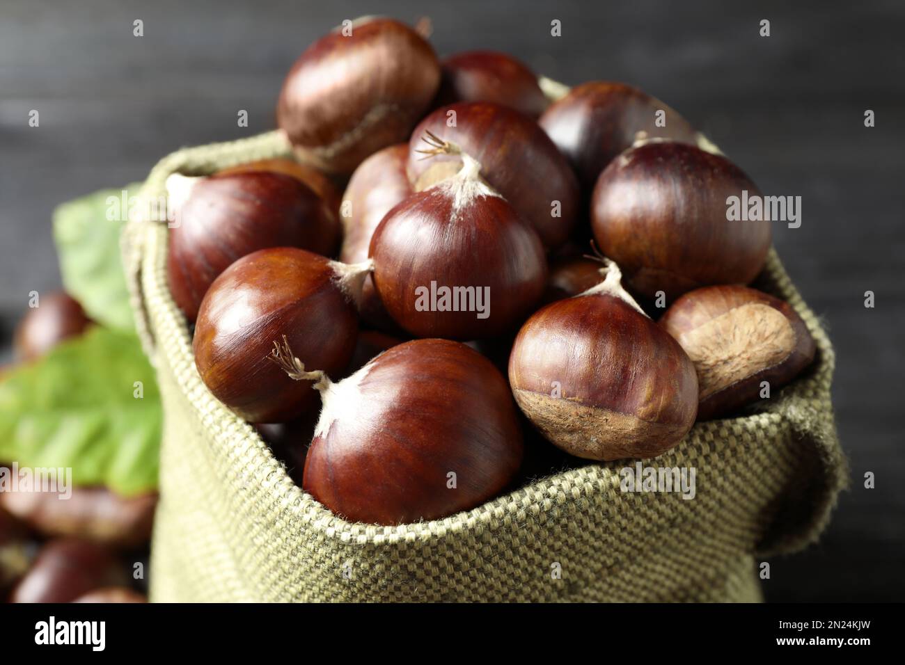 Fresh sweet edible chestnuts in sack, closeup Stock Photo - Alamy