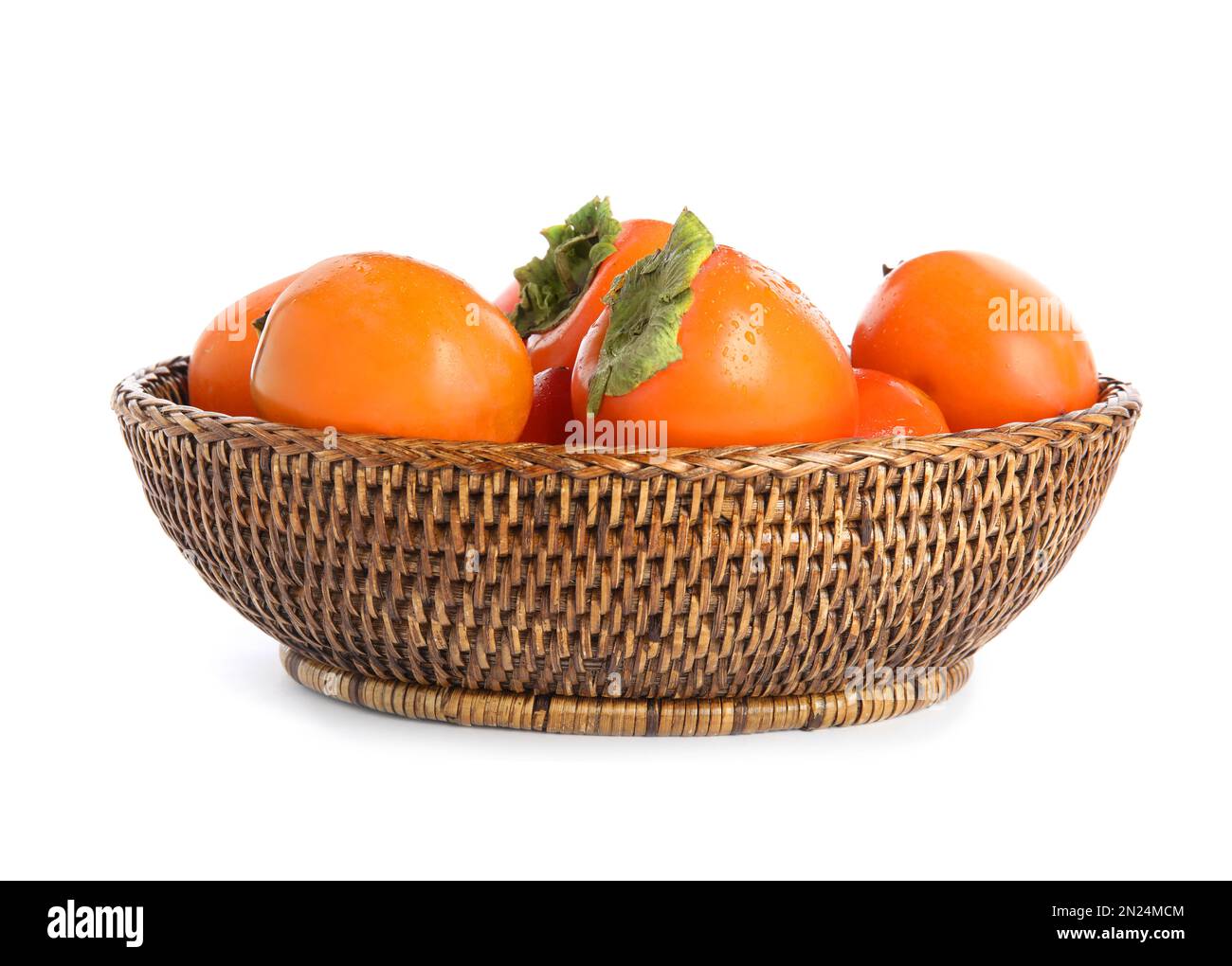 Wicker bowl with delicious persimmons isolated on white Stock Photo - Alamy