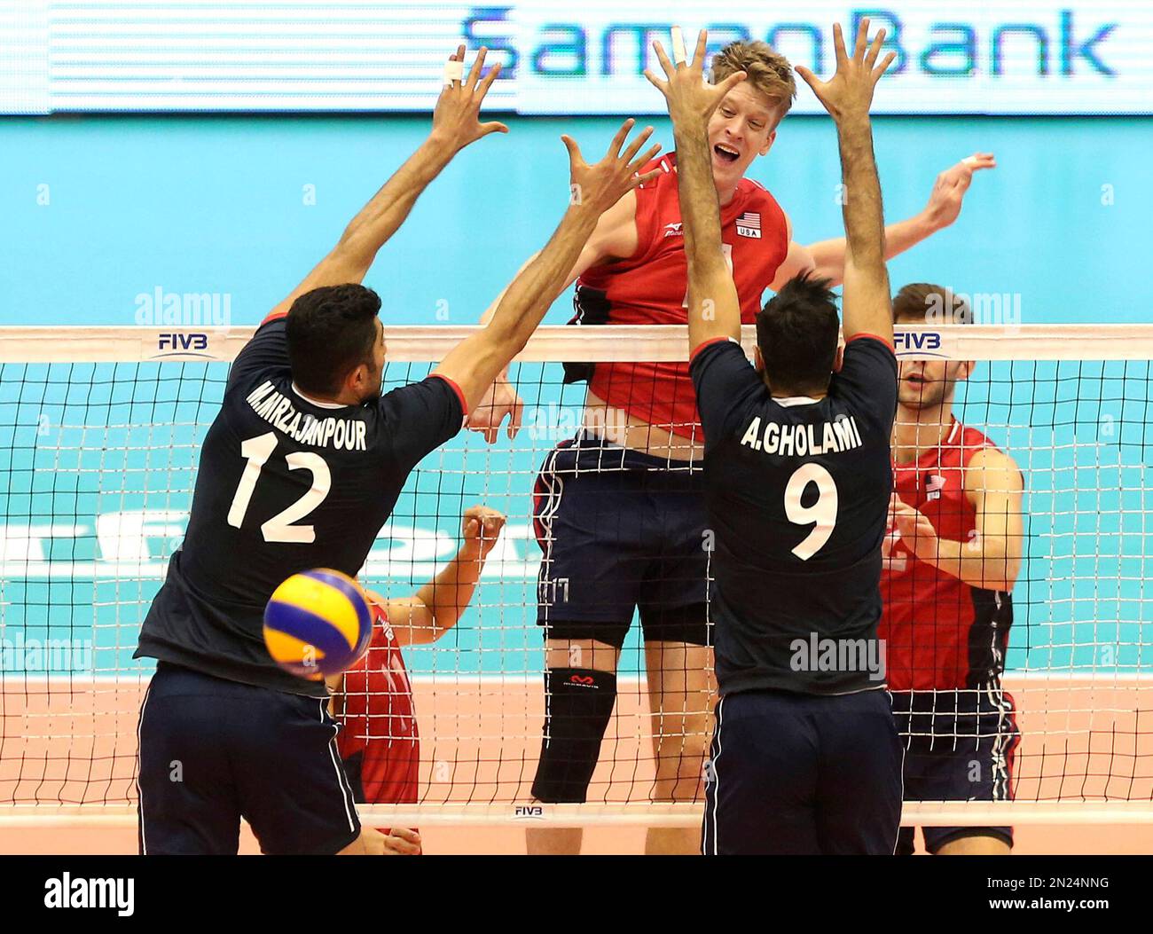 Maxwell Holt, center, of the United States spikes against Iran's Adel ...