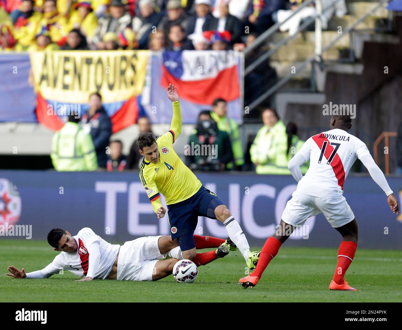 Peru's Carlos Zambrano, left, tackles Colombia's Santiago Arias during ...