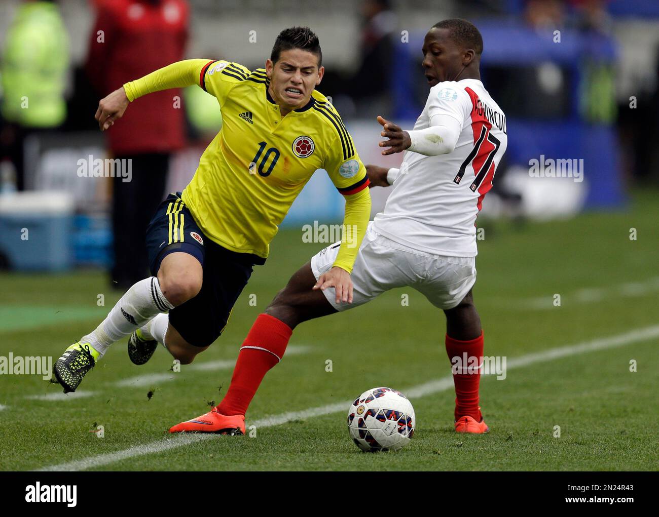 Colombia's James Rodriguez, left, is fouled by Peru's Luis Advincula ...