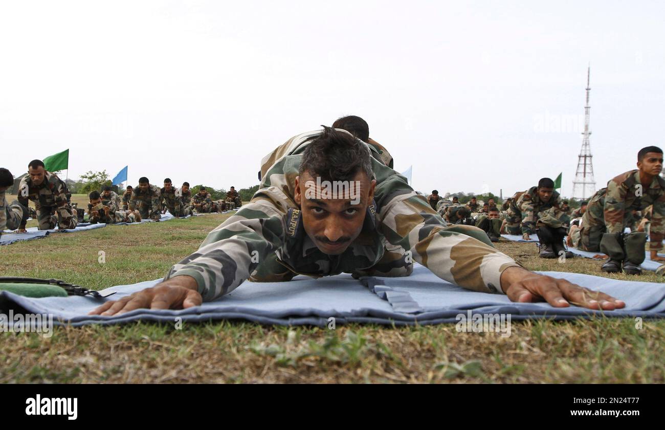 Indian army soldiers perform yoga at an army training area, in Chennai ...