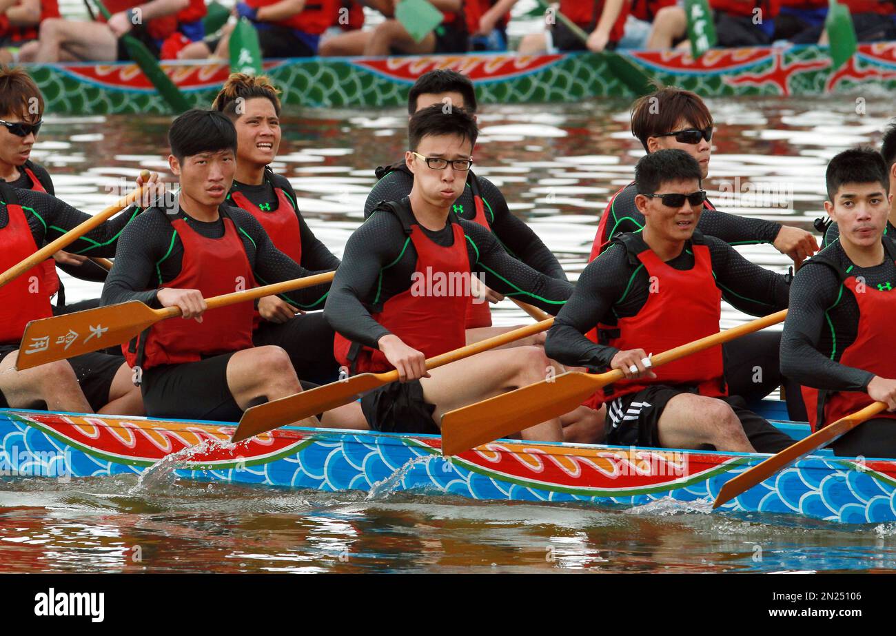 Members of a rowing team react after a traditional Chinese Dragon Boat ...
