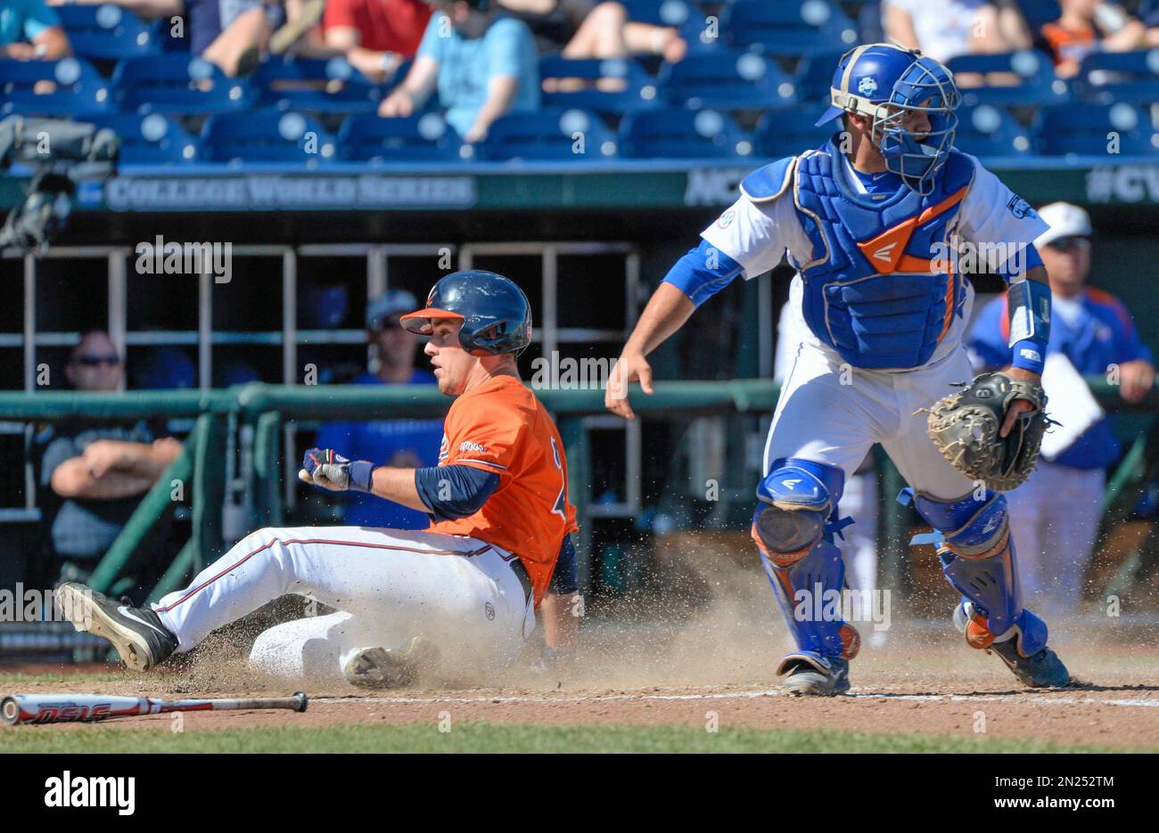 Virginia's Kevin Doherty (28) slides home before the throw to Florida ...