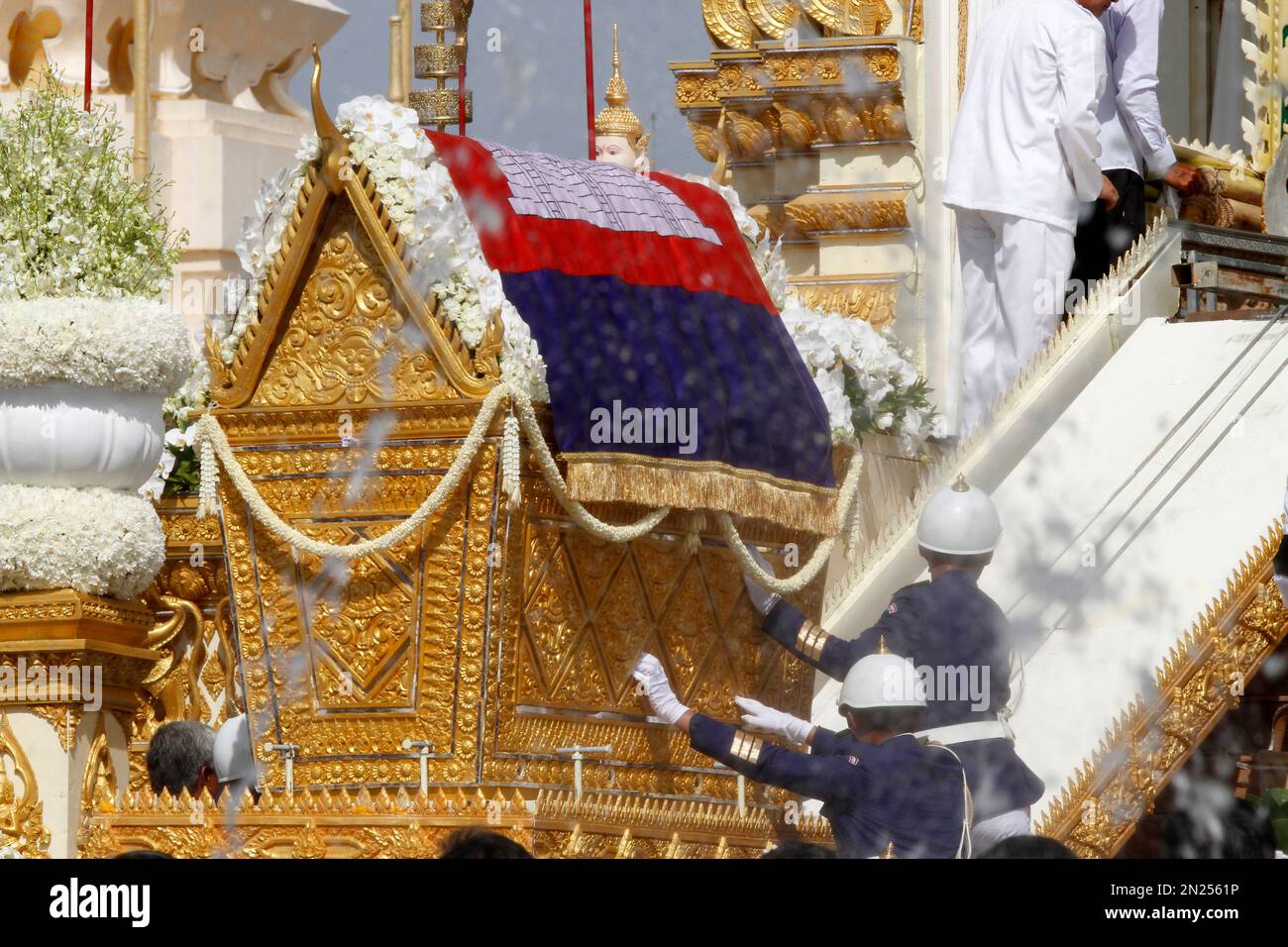 Cambodian honor guard loads the coffin of Chea Sim, a key Cambodian ...