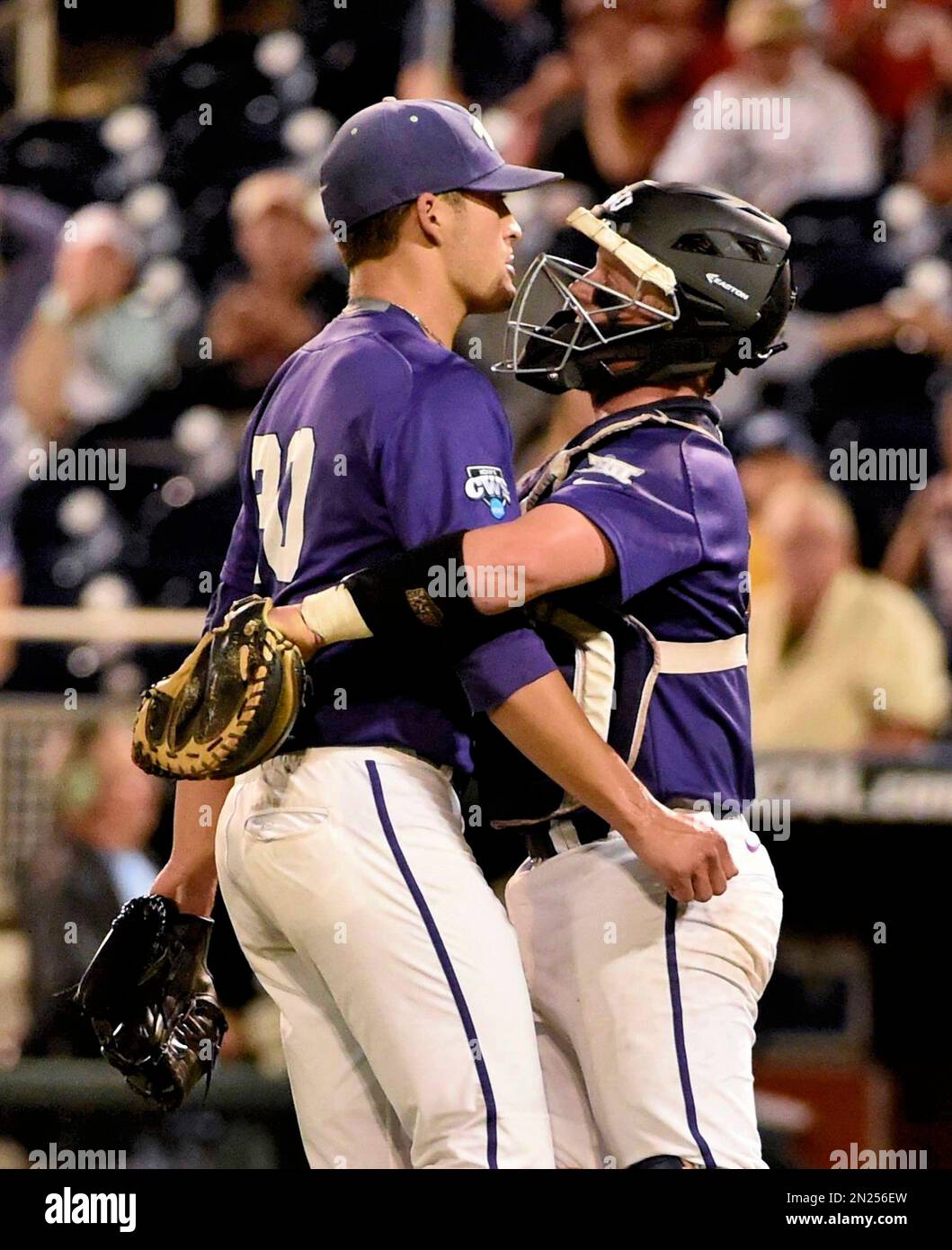 TCU pitcher Preston Guillory and catcher Evan Skoug, right, hug ...