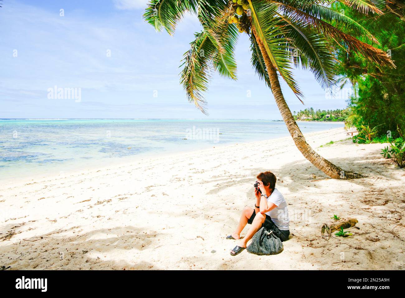 Rarotonga Cook Islands - November 3 2010; Tourists sitting under palm ...