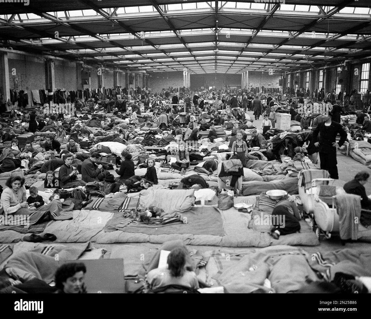 The hall of a huge West Berlin factory serves as a temporary shelter ...