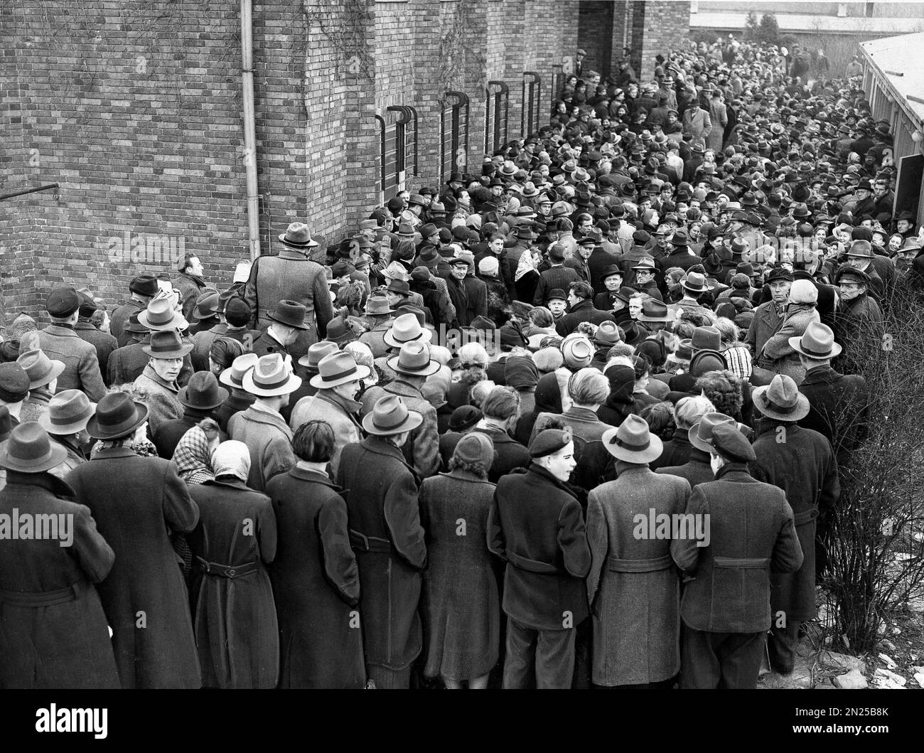 Refugees stand 10 abreast outside the West Berlin refugee headquarters ...