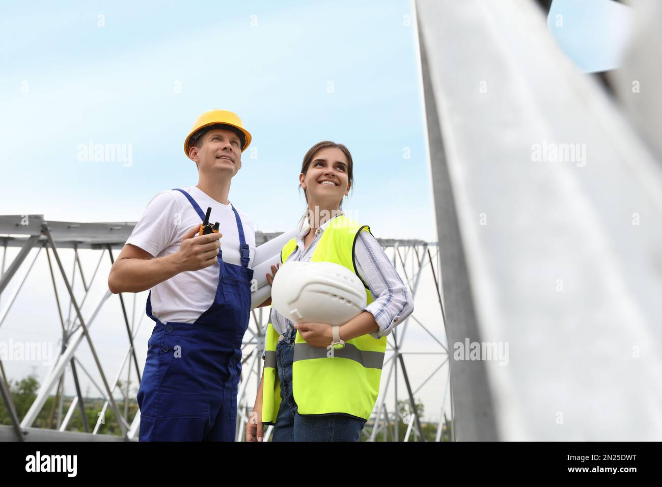 Professional engineers working on installation of electrical substation ...