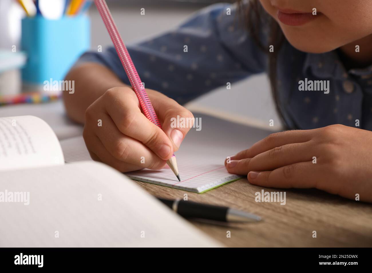 Preteen girl doing homework at table, closeup Stock Photo - Alamy