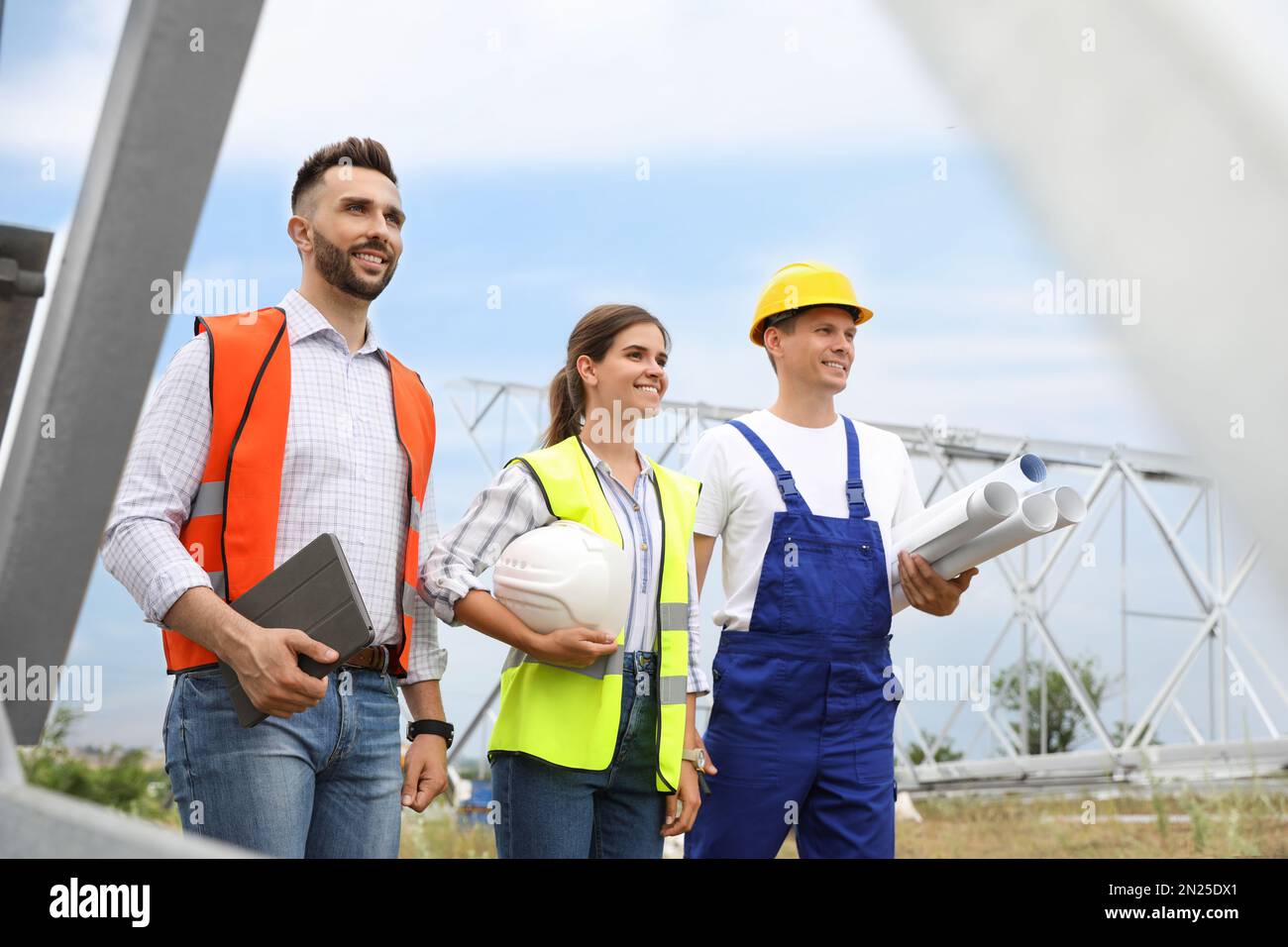 Professional engineers working on installation of electrical substation ...