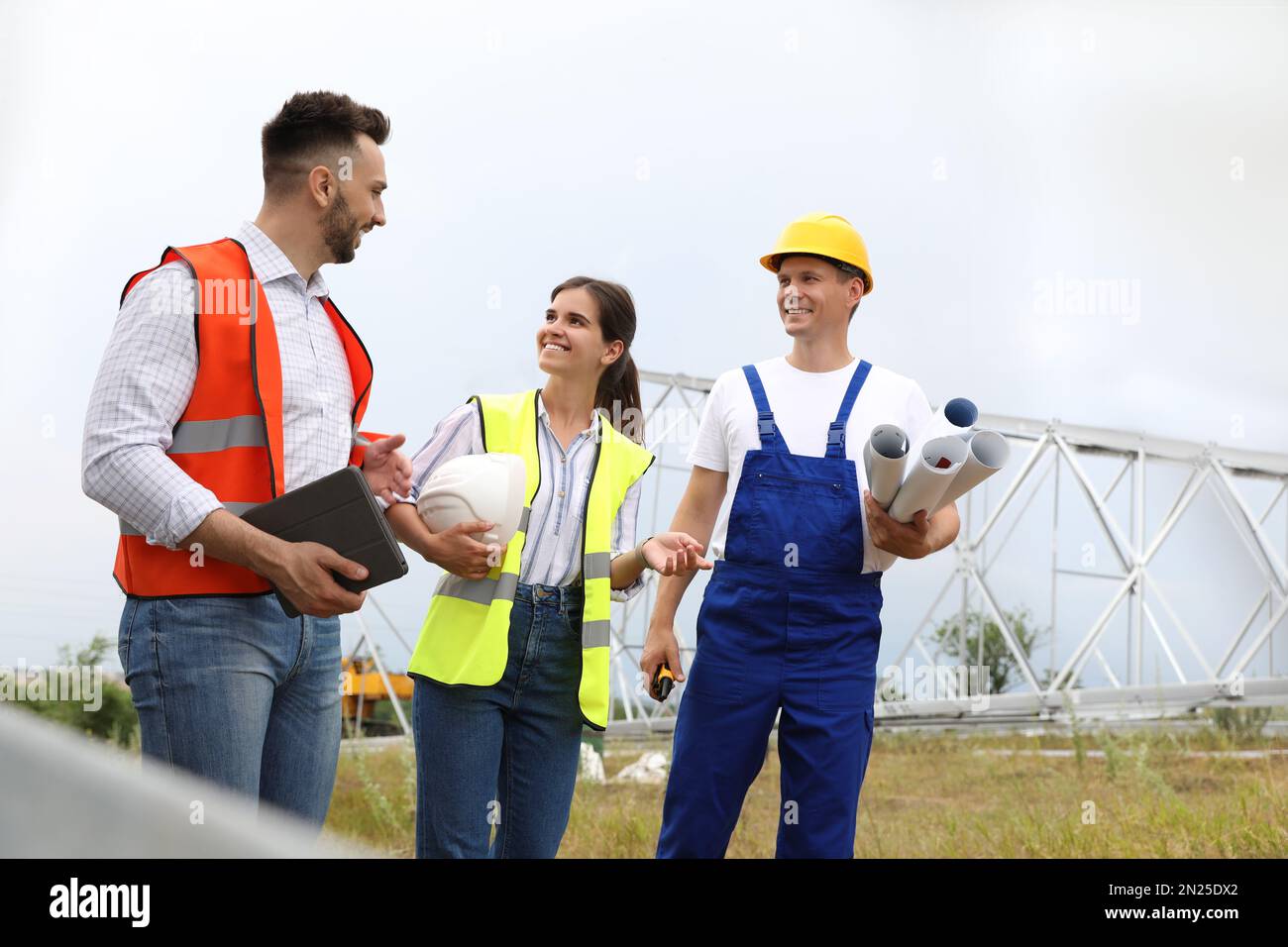 Professional engineers working on installation of electrical substation ...