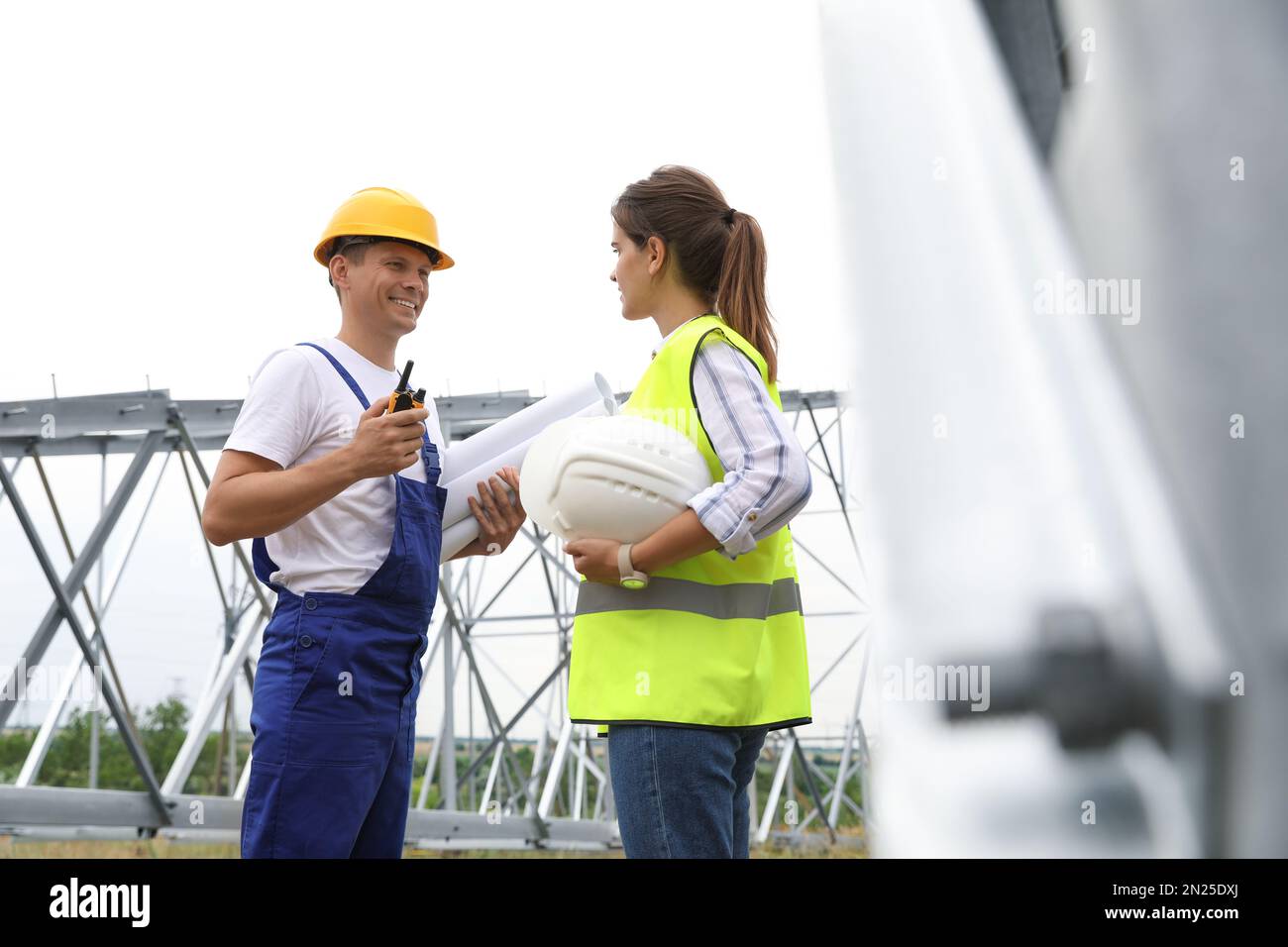 Professional engineers working on installation of electrical substation ...