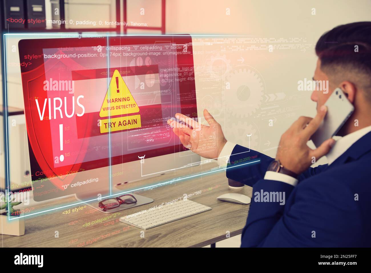 Office worker in front of computer with warning about virus attack on ...