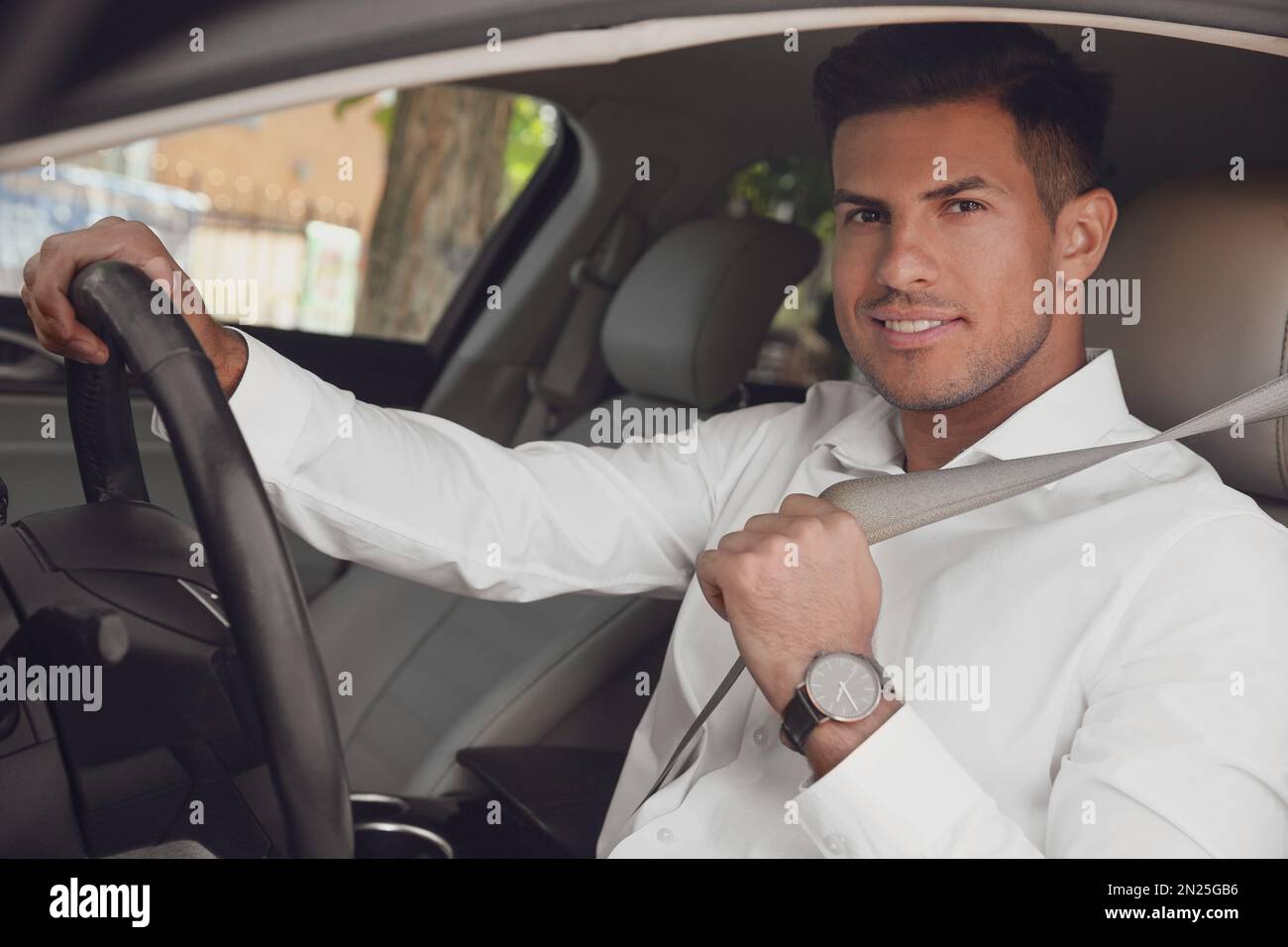 Male driver with fastened safety belt in car Stock Photo - Alamy