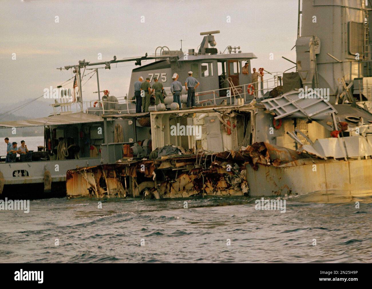 Sailors inspect damage to the U.S. Navy destroyer USS Frank E. Evans ...
