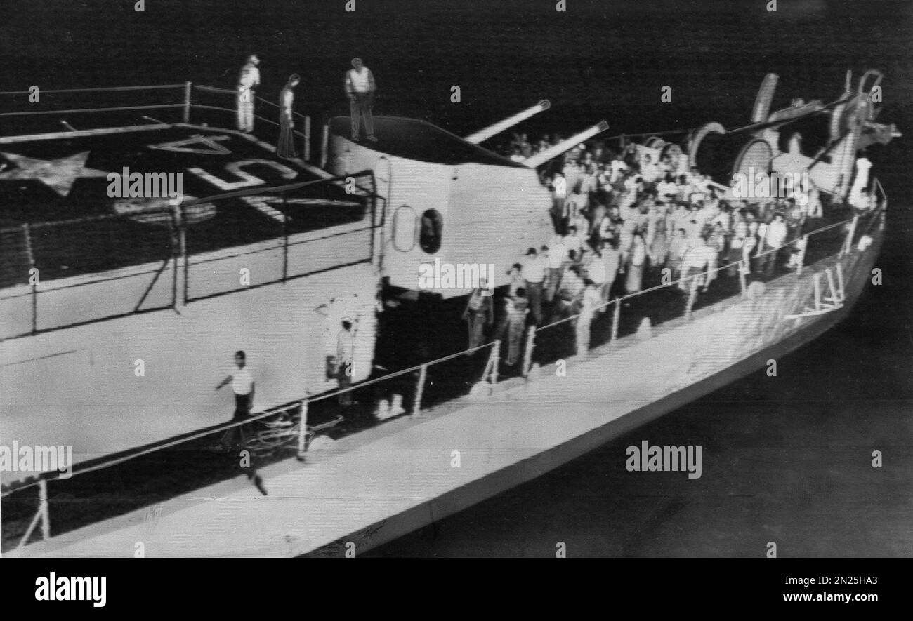 U.S. sailors crowd the fantail of the Navy destroyer USS Frank E. Evans ...