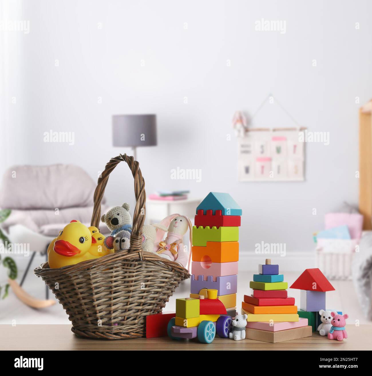 Set of different cute toys on wooden table in children's room Stock ...