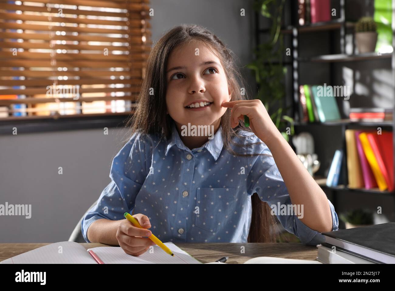 Cute student girl sitting table hi-res stock photography and images - Alamy