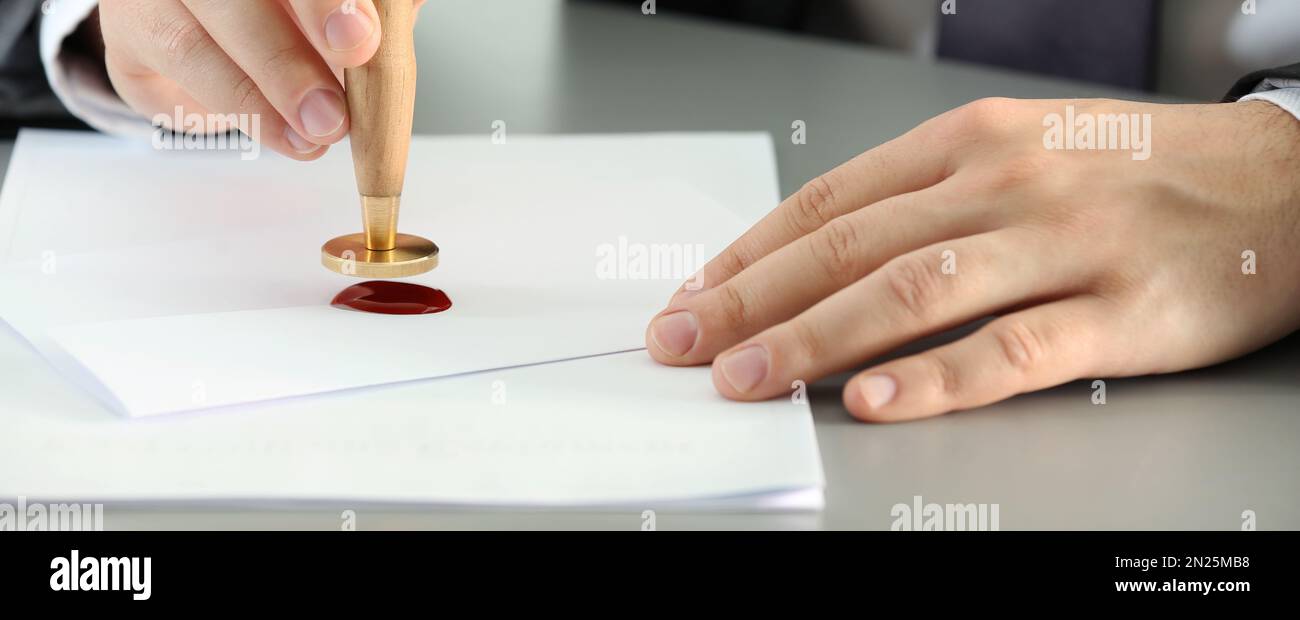 Notary stamping document at table, closeup. Banner design Stock Photo ...